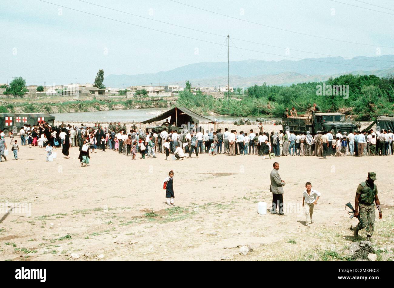 Kurdish refugees gather at a health clinic and water purification ...