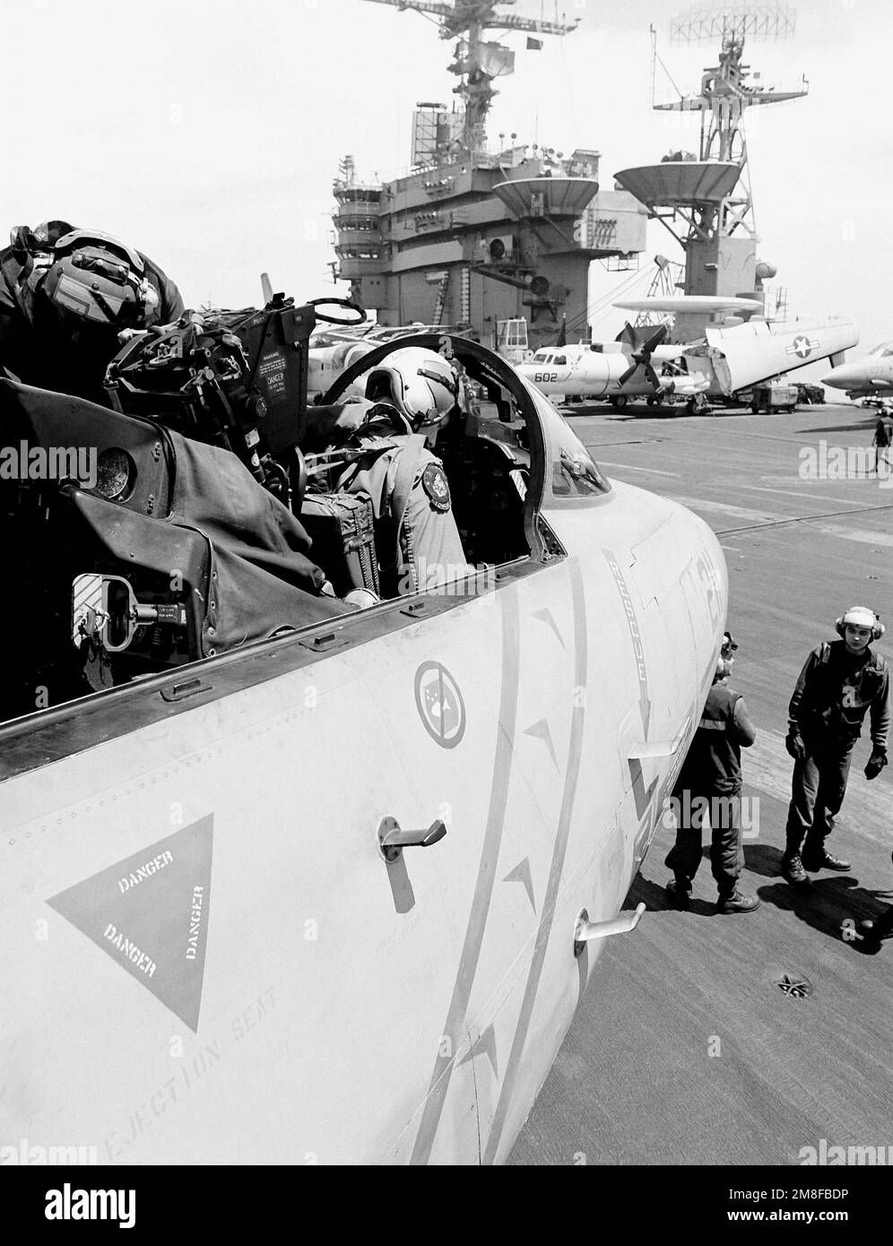 A pilot from Fighter Squadron 84 (VF-84) is assisted by his plane ...