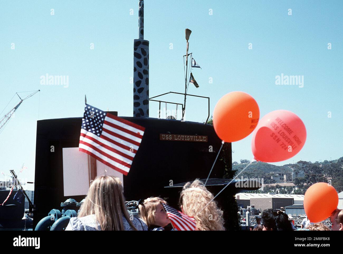 Family members and friends wait on the pier as the nuclear-powered ...