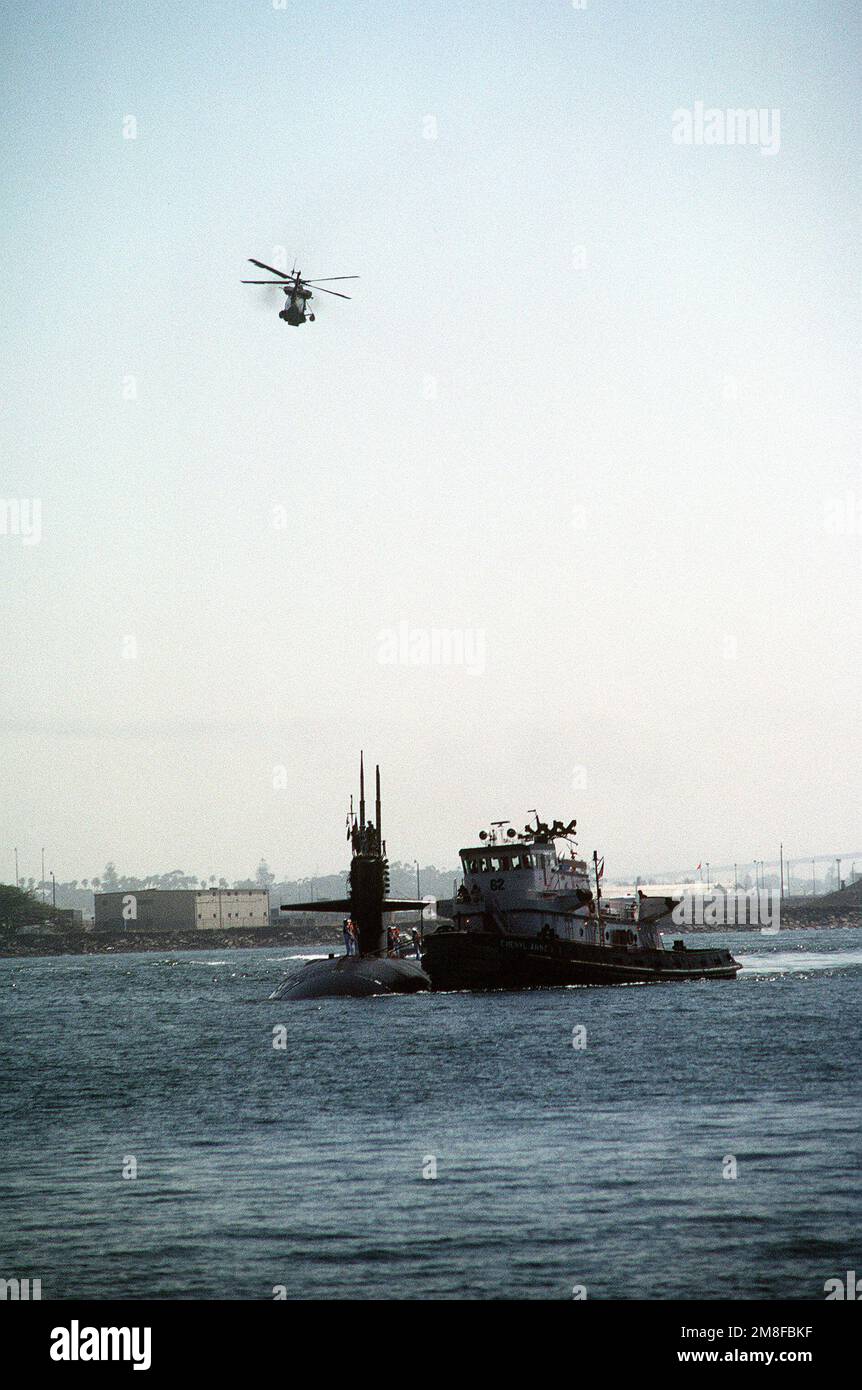 A commercial tug pushes the nuclear-powered attack submarine USS ...
