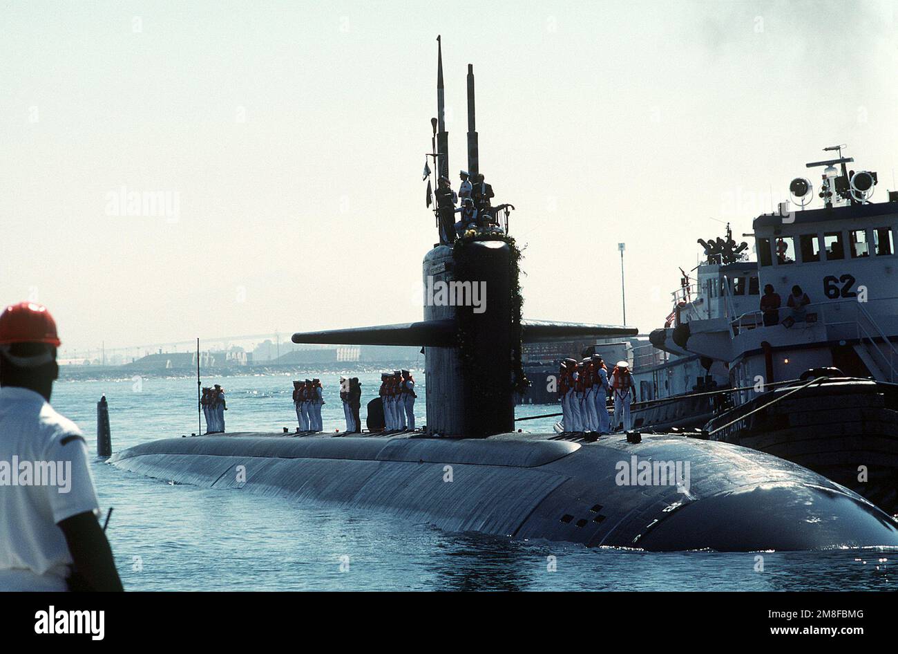 Line handlers aboard the nuclear-powered attack submarine USS ...