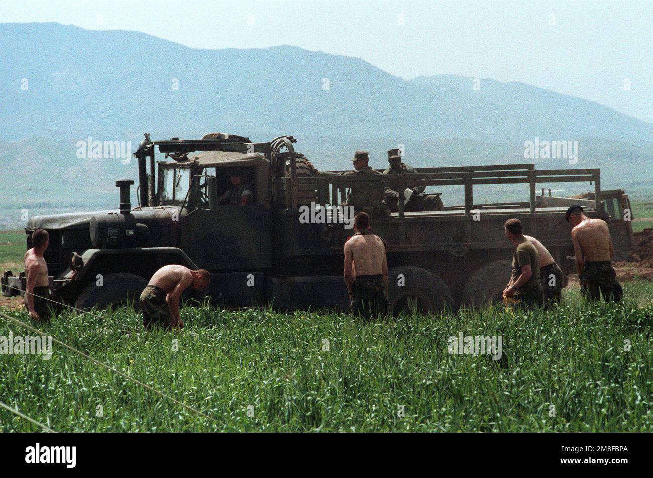 Members of a U.S. Navy Beachmaster gather around an M-939 5-ton cargo ...