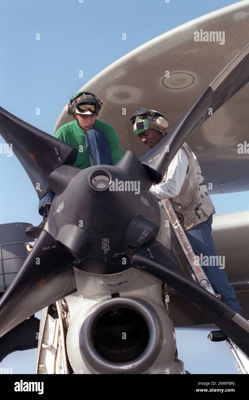 Members of Airborne Early Warning Squadron 124 (VAW-124) service an ...