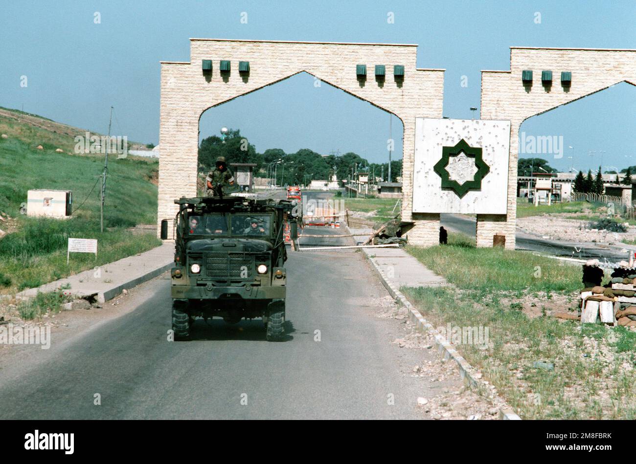 U.S. military personnel in an M-939 5-ton cargo truck pass over the ...