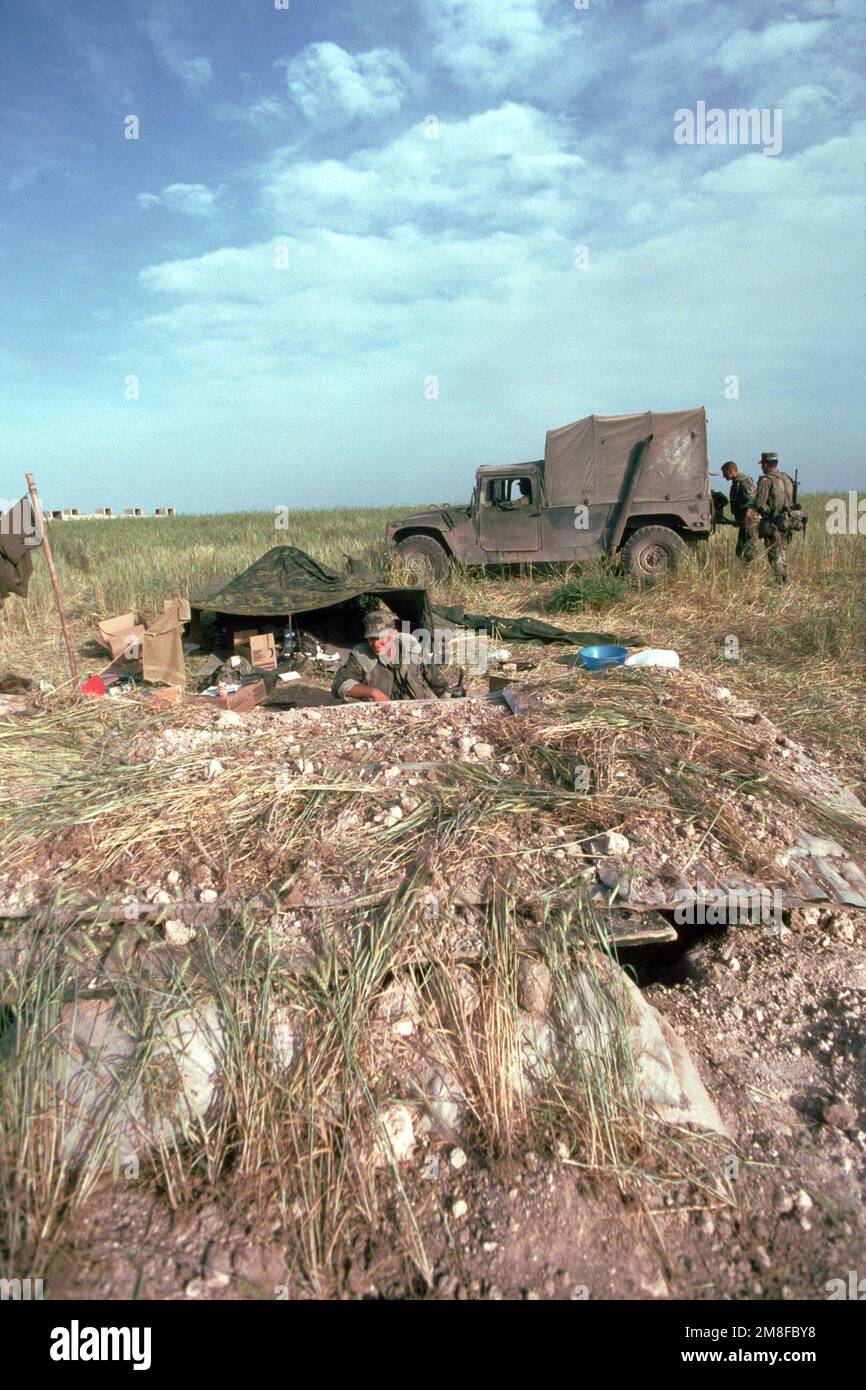 An M998 High-Mobility Multipurpose Wheeled Vehicle (HMMWV) stops at a ...
