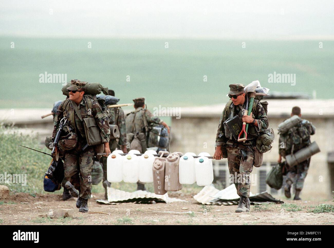 Members of the 2nd Battalion, 8th Marine Regiment carry water to their ...