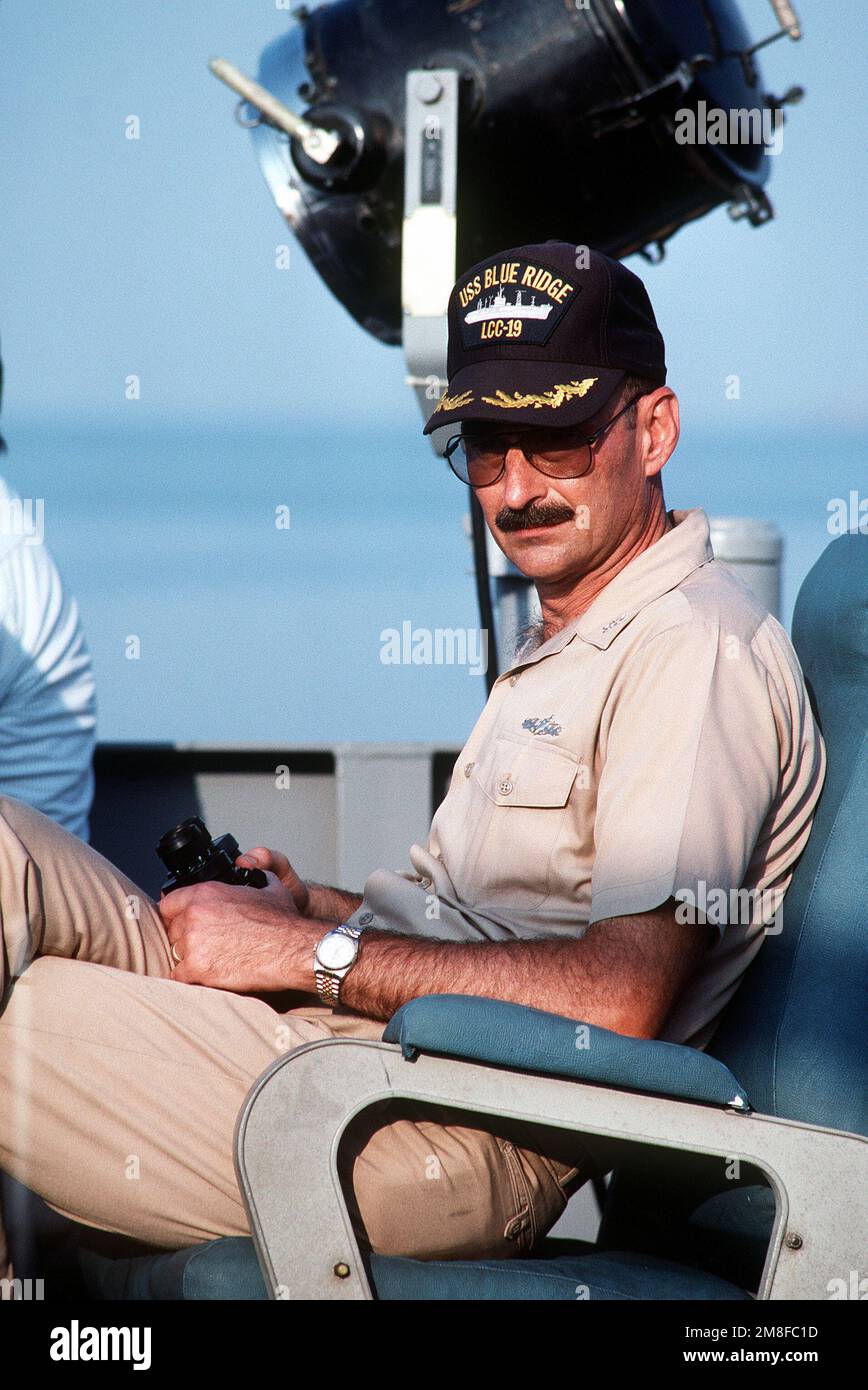 An officer takes a break aboard the amphibious command ship USS BLUE ...