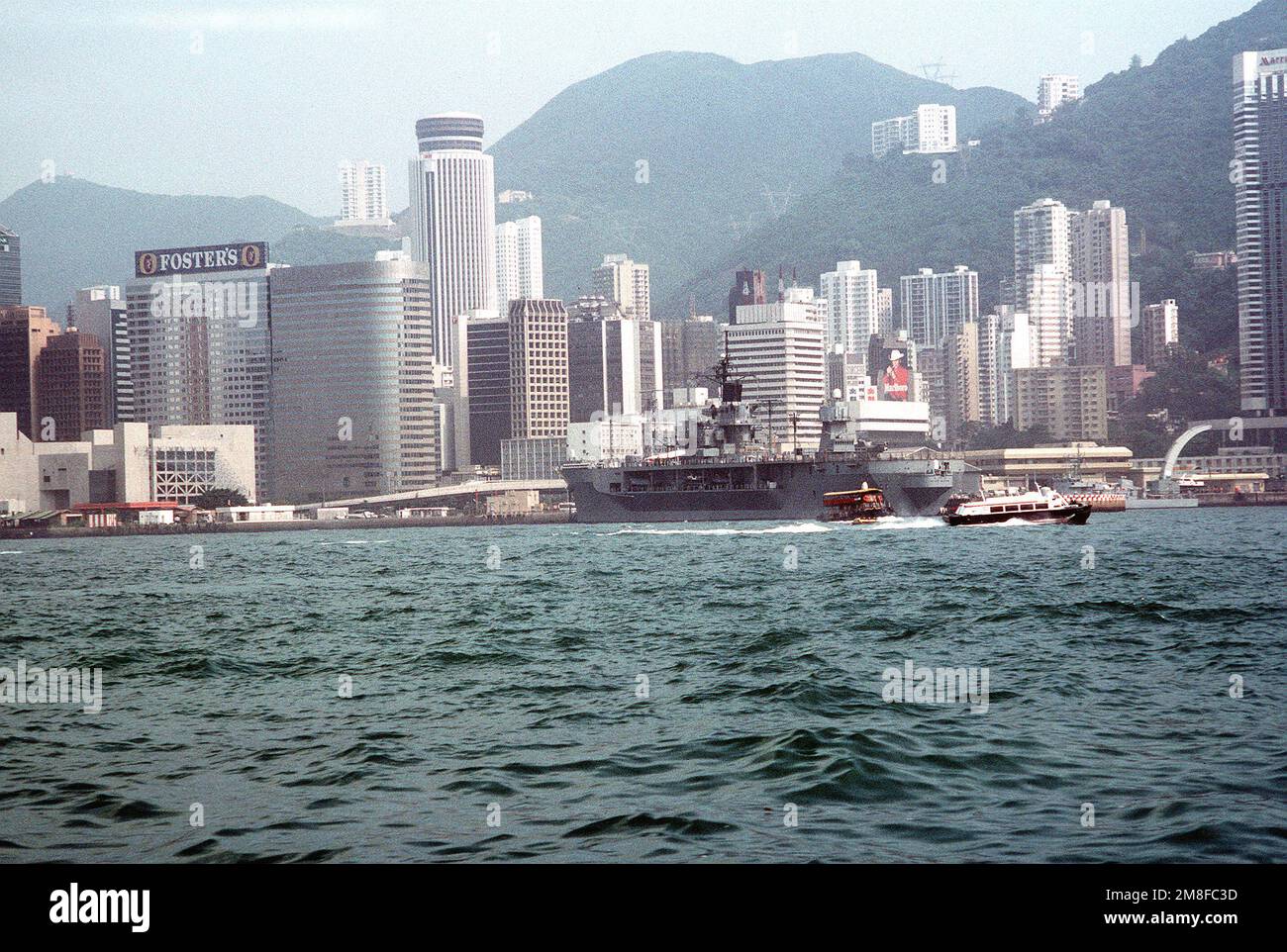 Commercial craft pass the amphibious command ship USS BLUE RIDGE (LCC ...