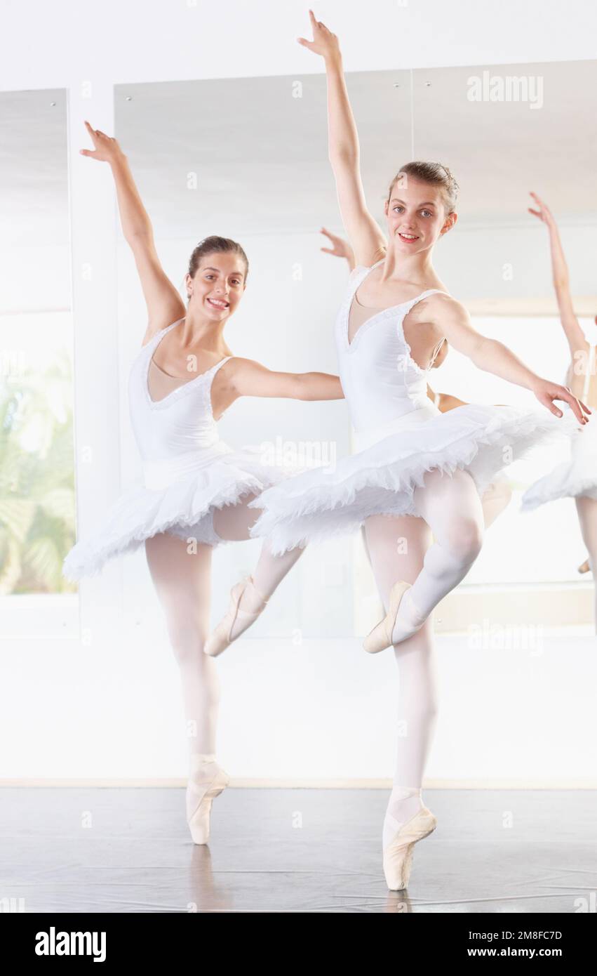 Portrait of mirrored movement. Full length shot of two ballerinas ...