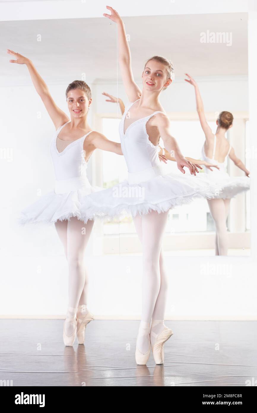Dancing in perfect unison. Full length shot of two ballerinas ...