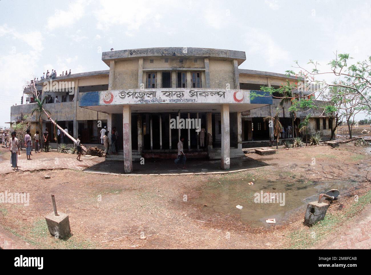 An exterior view of the local hospital, overflowing with people in the ...