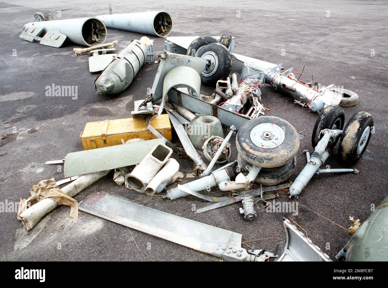 Fragments of an aircraft litter the ground in the aftermath of a ...