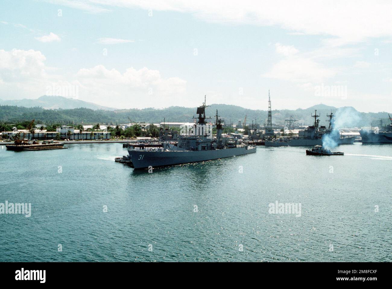 The large harbor tug WAUWATOSA (YTB-775) approaches the guided missile ...