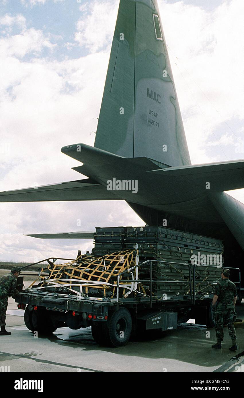 Members of t he 5072nd Munitions Maintenance Squadron load ordnance ...