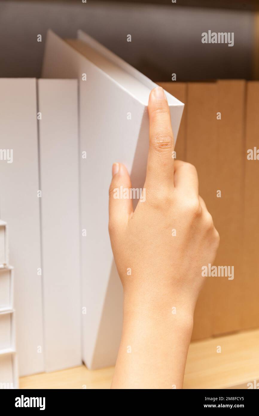 Choose a book from the shelf Stock Photo - Alamy