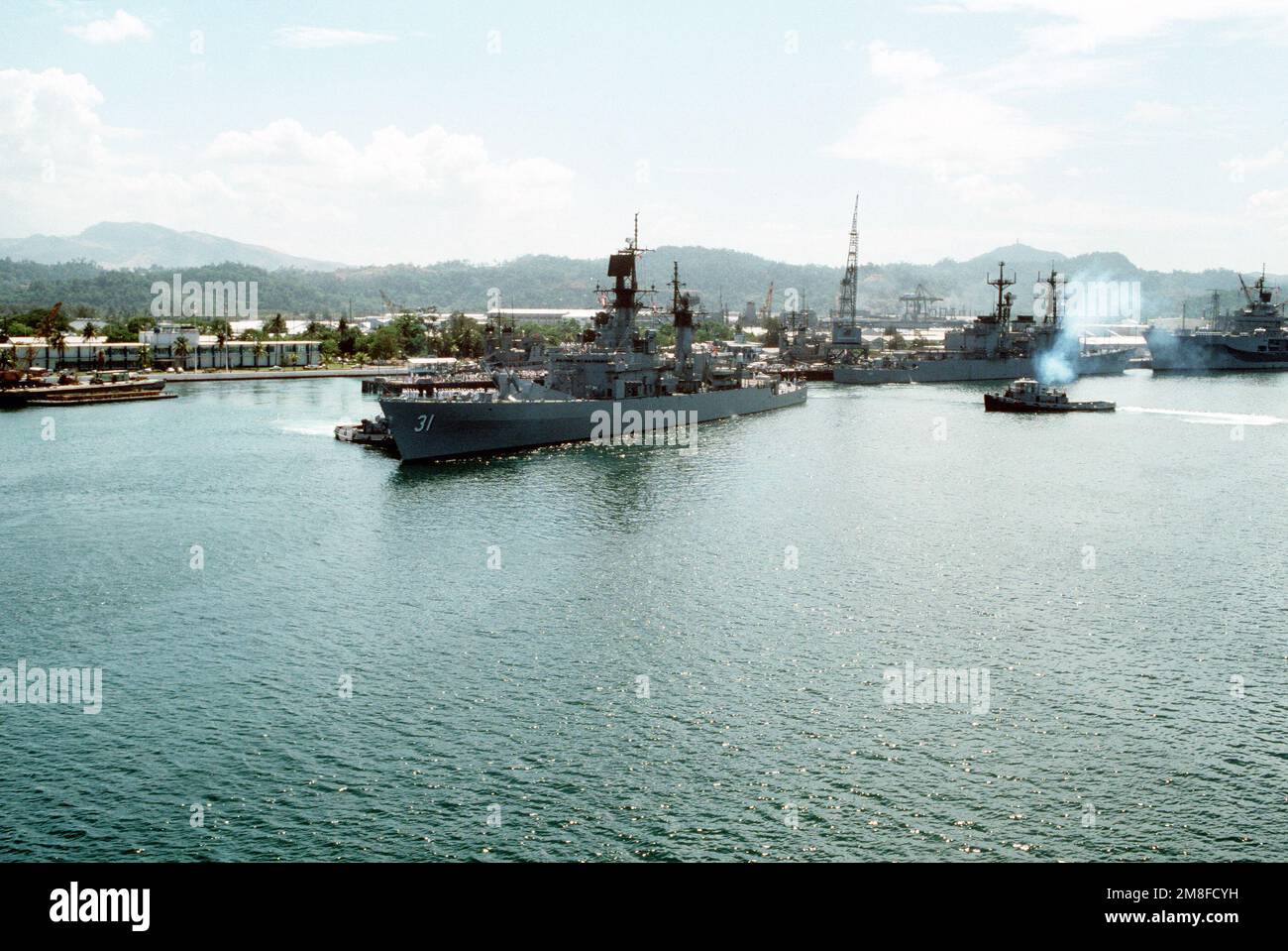 The large harbor tug WAUWATOSA (YTB-775) approaches the guided missile ...