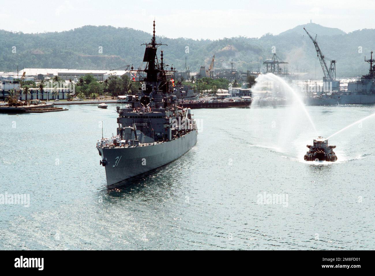 The large harbor tug WAUWATOSA (YTB-775) escorts the guided missile ...