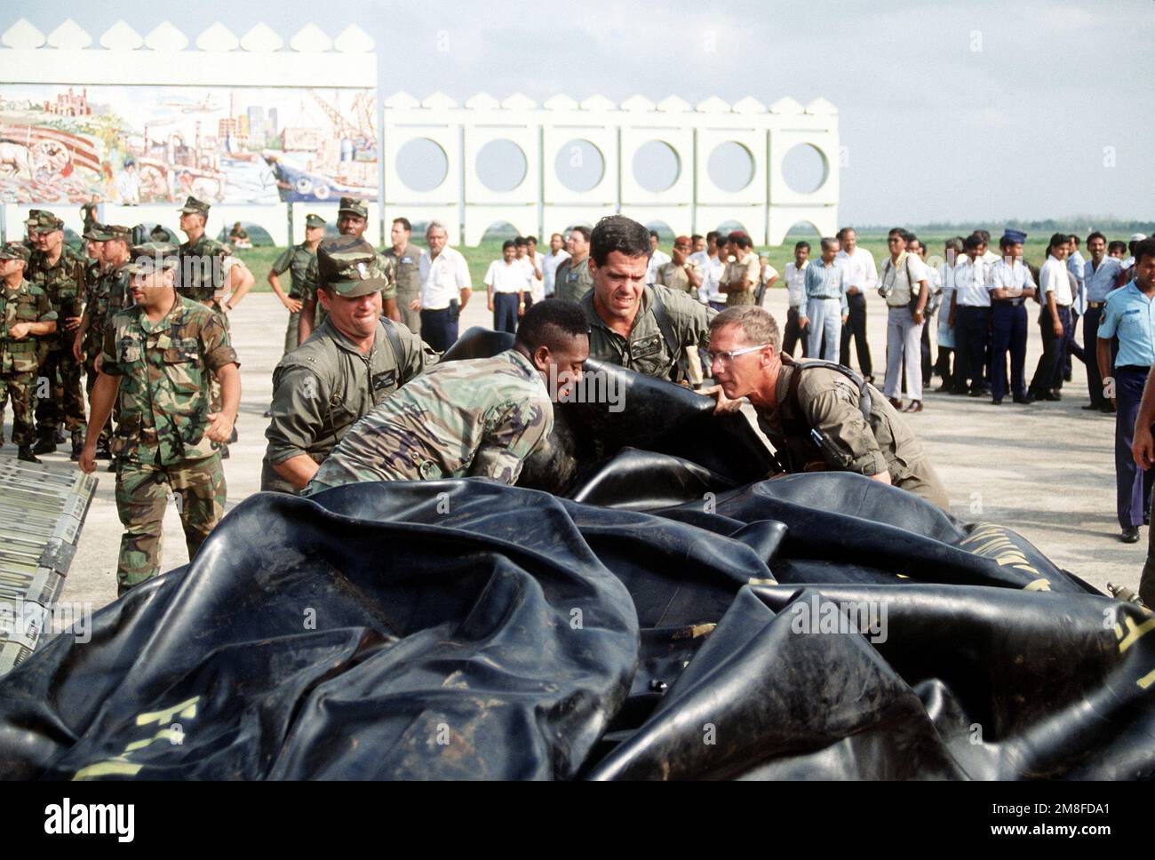 U.S. military personnel prepare to lift empty fuel bladders during ...