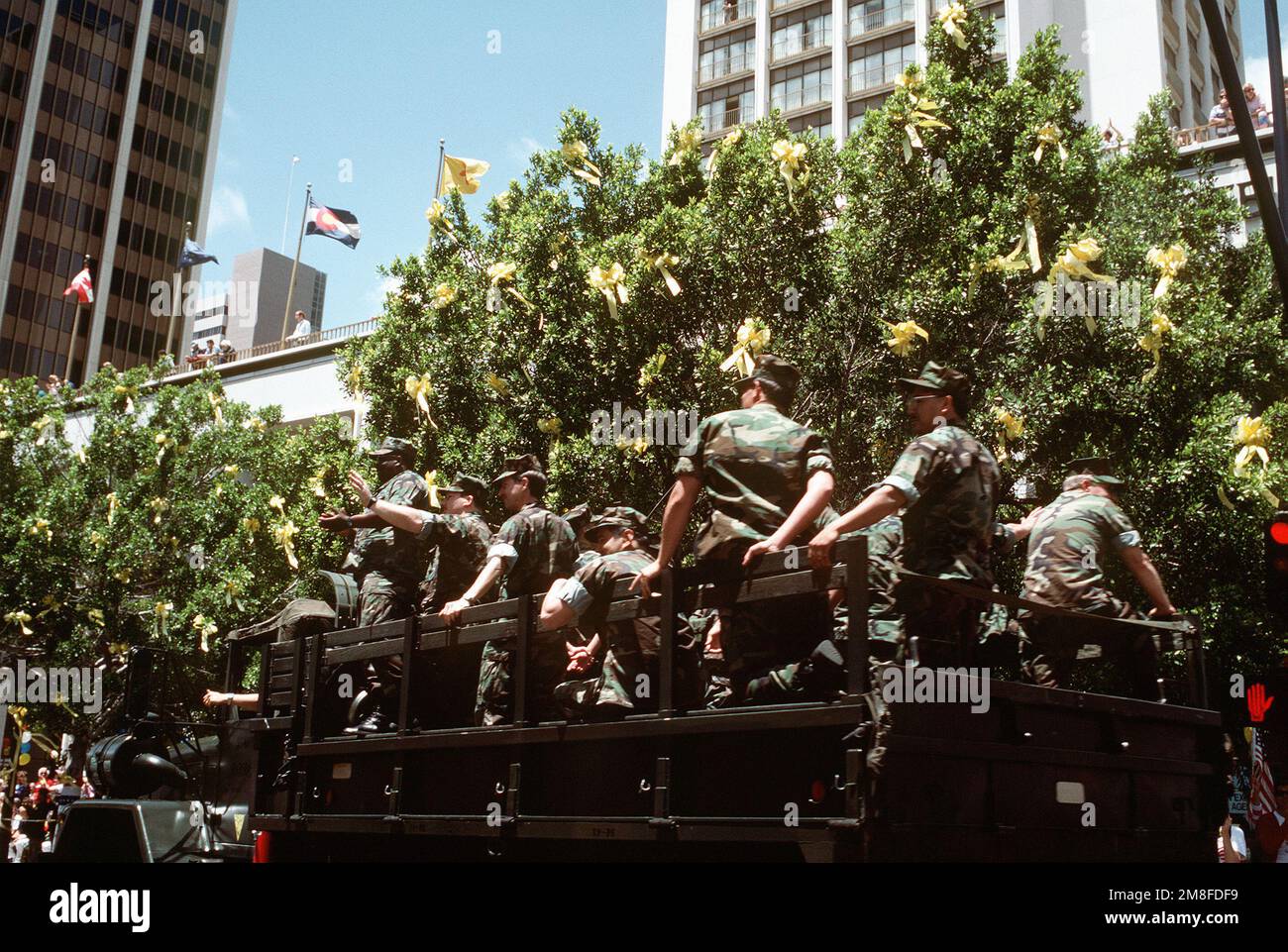 Members of a Navy shore unit ride in the back of an M-939 5-ton truck ...