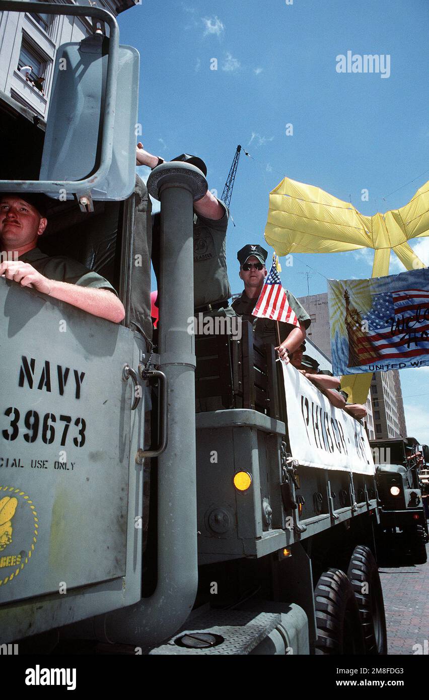 Seabees from Amphibious Construction Battalion One (ACB-1) ride in an M ...