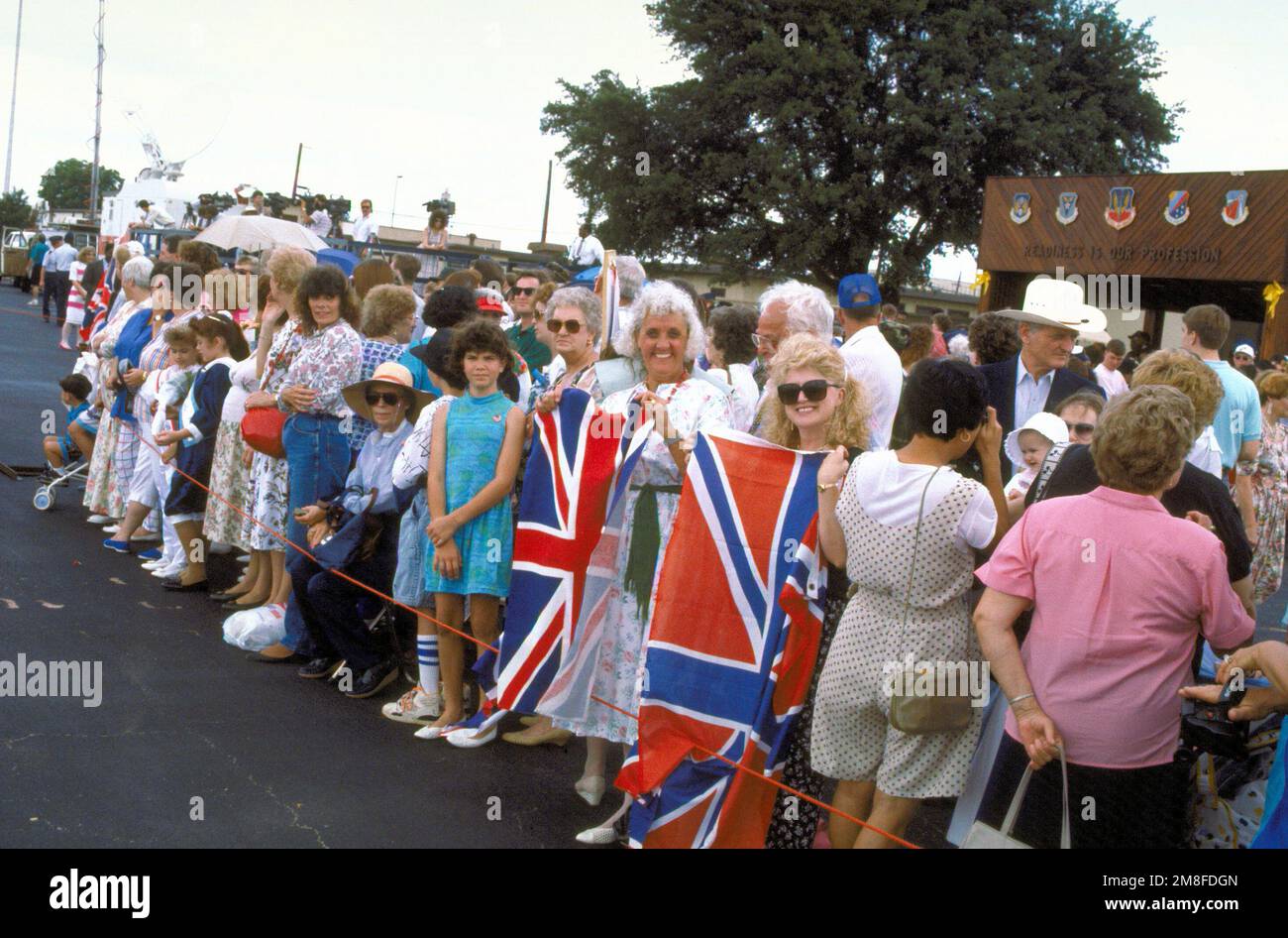 A crowd gathers to greet England's Queen Elizabeth II and her husband ...