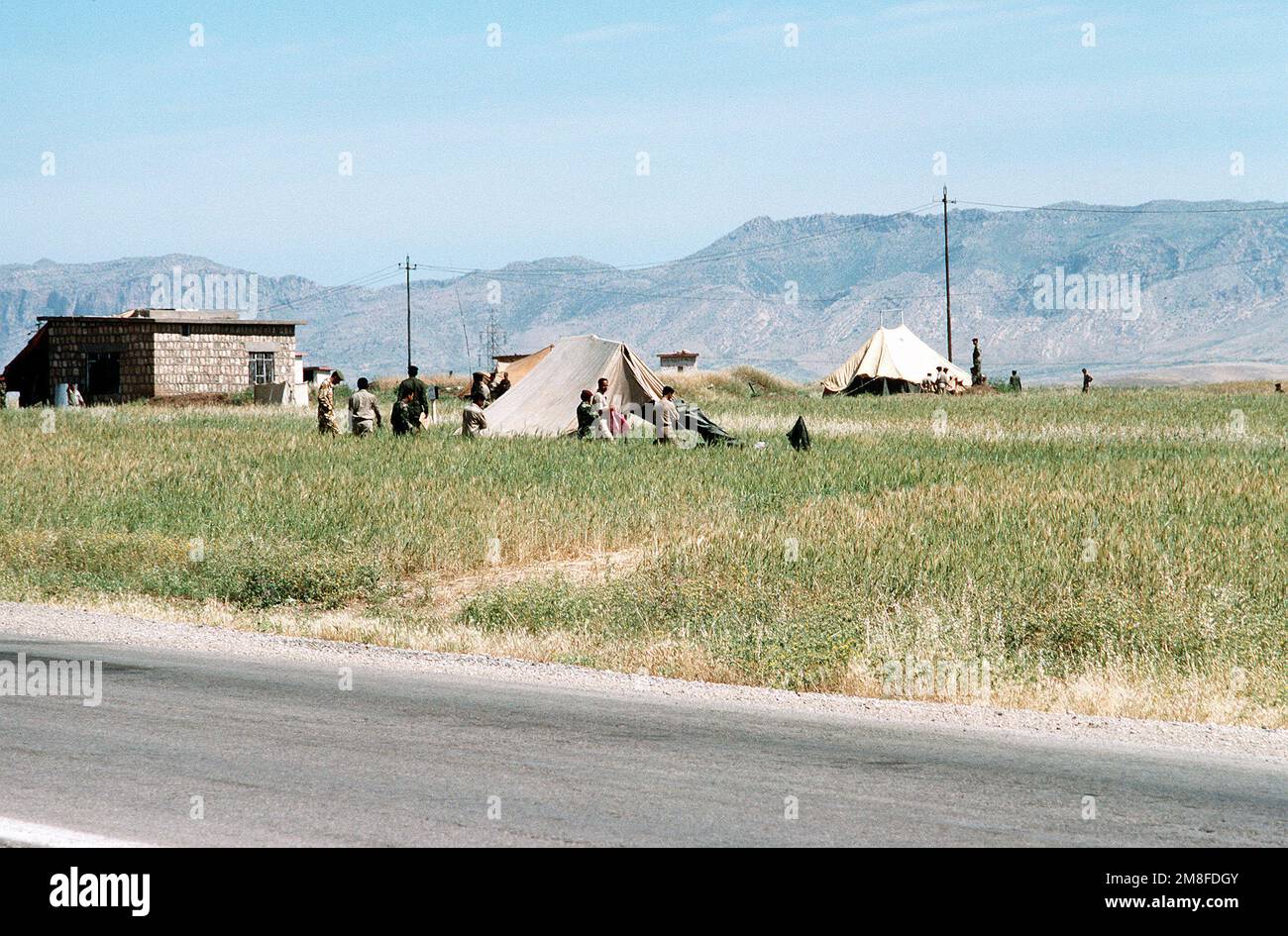 Soldiers gather outside a tent in the aftermath of Operation Desert ...