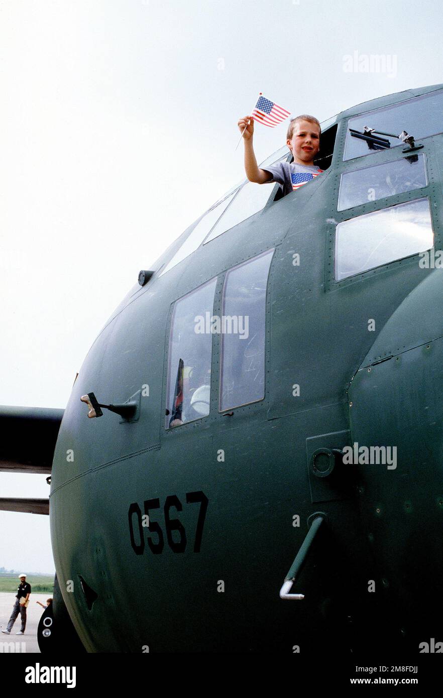 Tyler Renshaw, a first grade student at Stewardson-Strasburg School, waves an American flag from ...