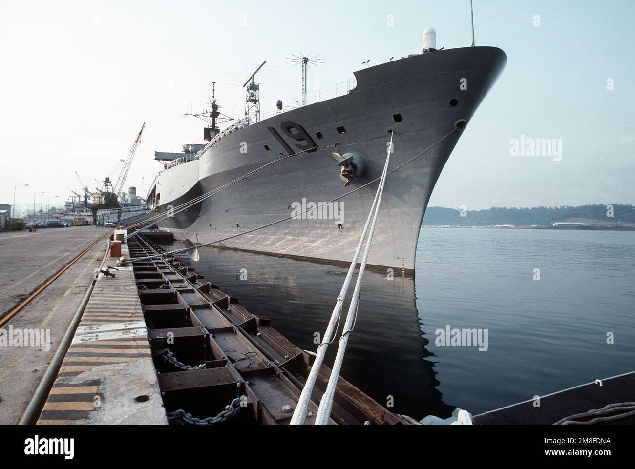 The amphibious command ship USS BLUE RIDGE (LCC-19) is moored to a pier ...