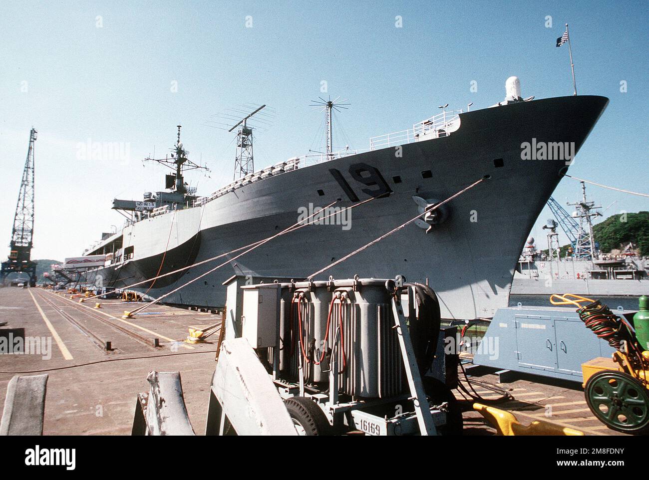 The amphibious command ship USS BLUE RIDGE (LCC-19) is moored to a pier ...
