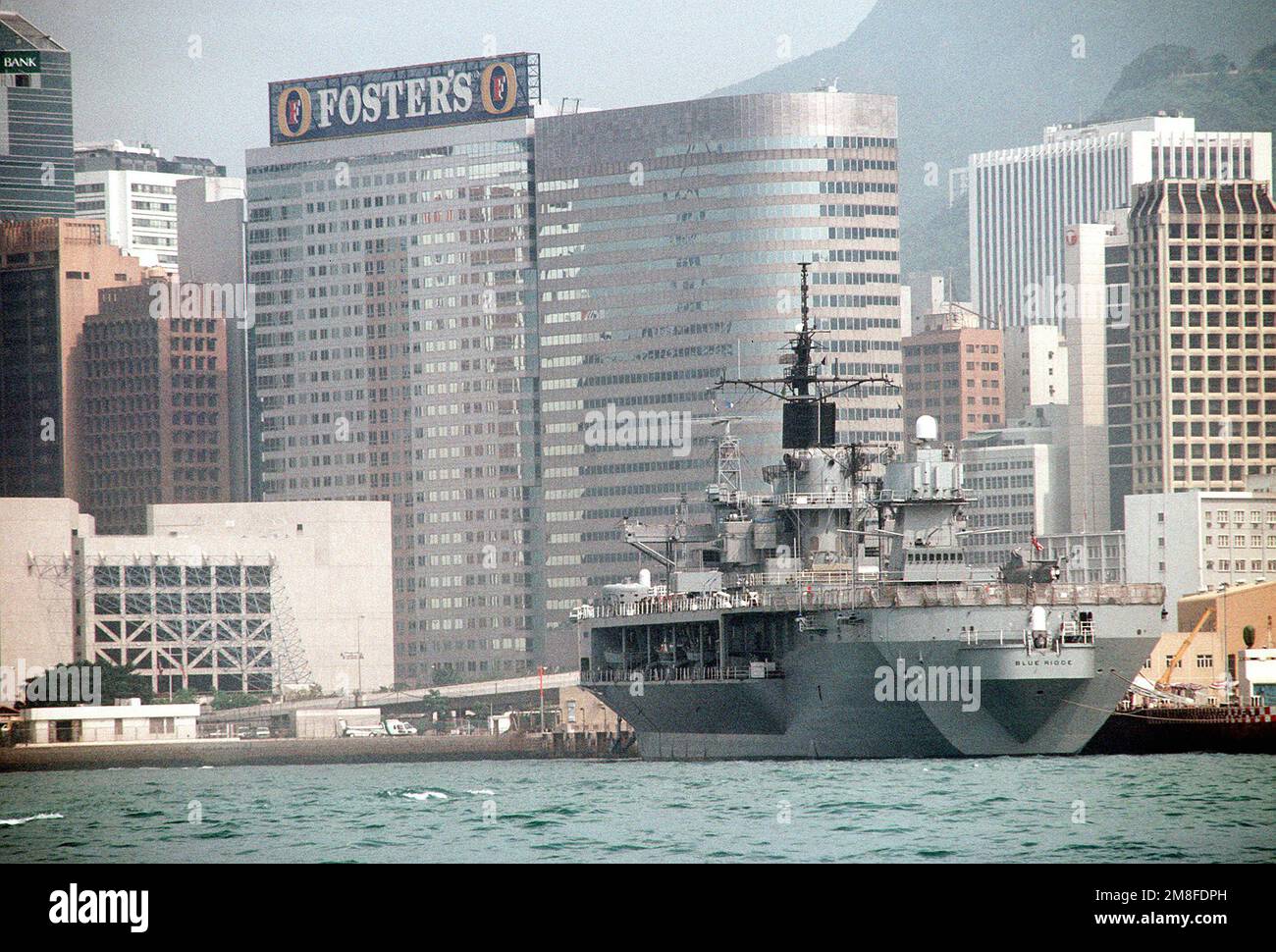 The amphibious command ship USS BLUE RIDGE (LCC-19) is moored to a pier ...