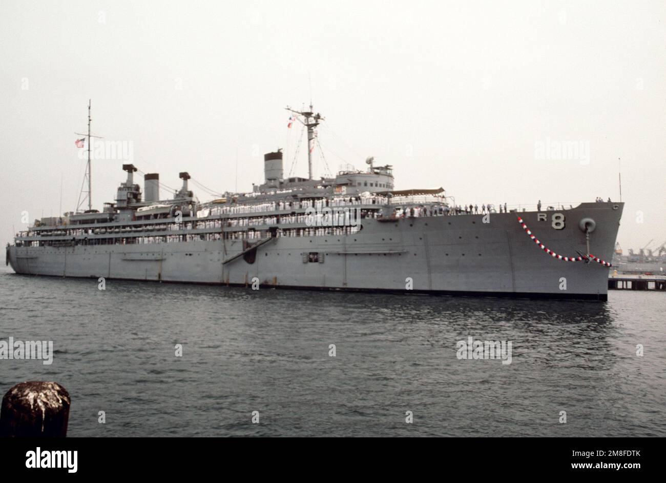 The crew of the repair ship USS JASON (AR-8) mans the rails as the ship ...