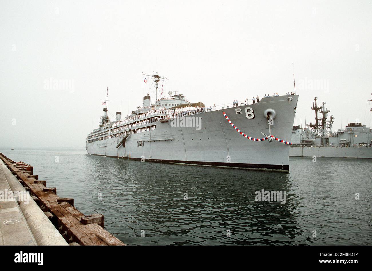The repair ship USS JASON (AR-8) makes its way to the pier as it ...