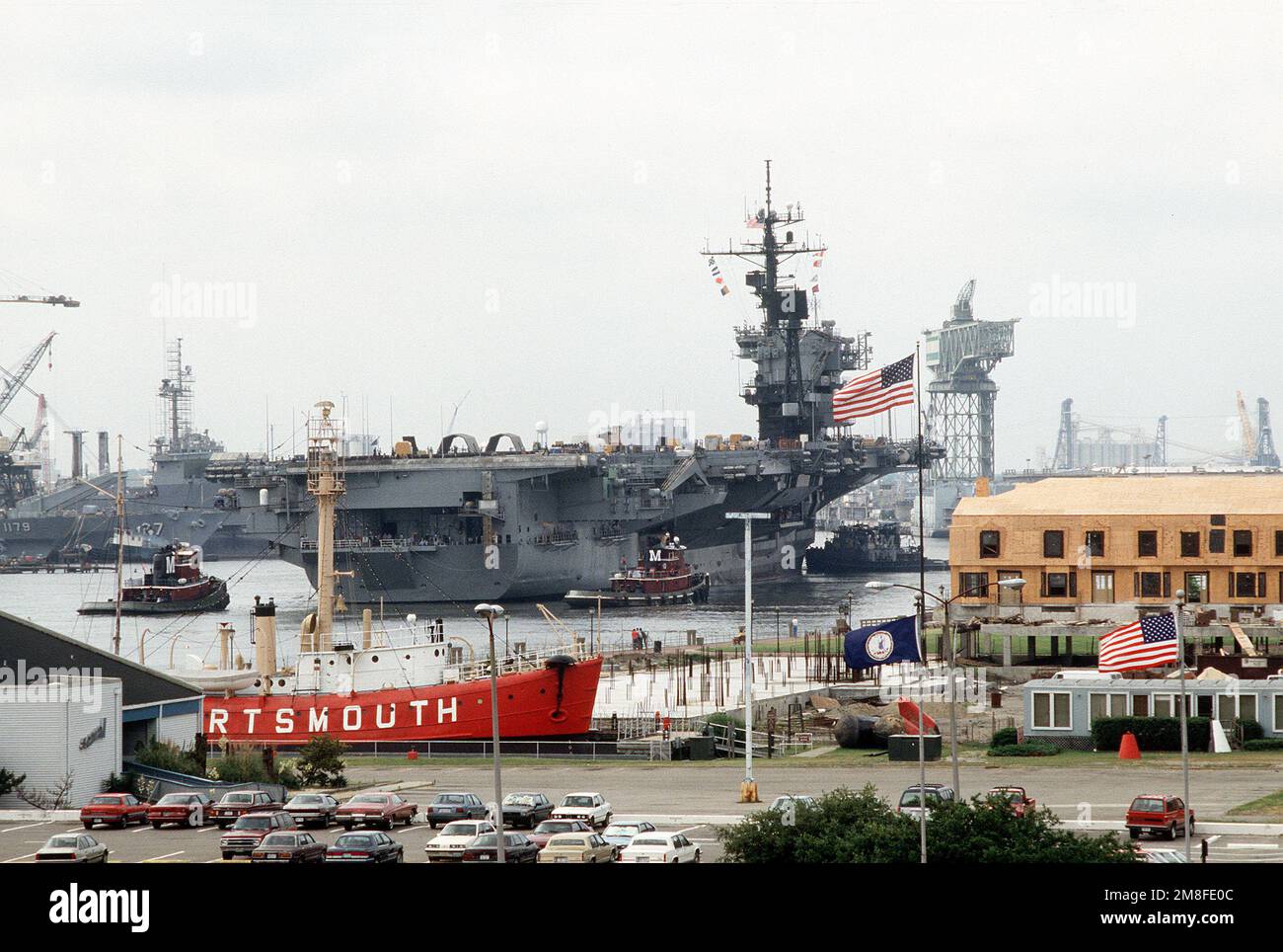 Large harbor tugs approach the aircraft carrier USS JOHN F. KENNEDY (CV ...
