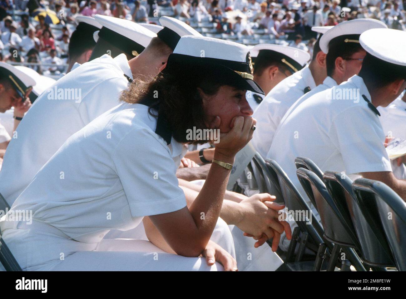 A member of the Naval Academy's Class of 1994 sits with the other ...