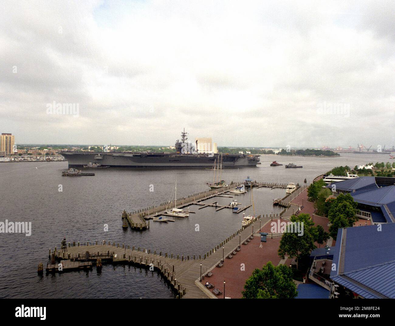 Large harbor tugs approach the aircraft carrier USS JOHN F. KENNEDY (CV ...
