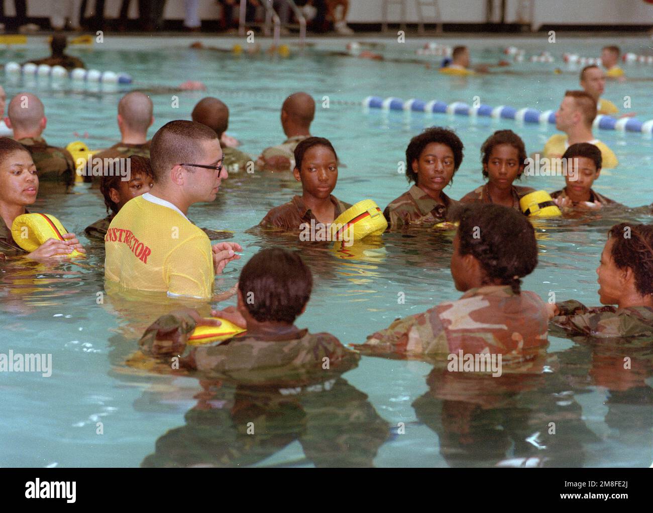 An instructor addresses a class of 4th Battalion recruits in a pool ...