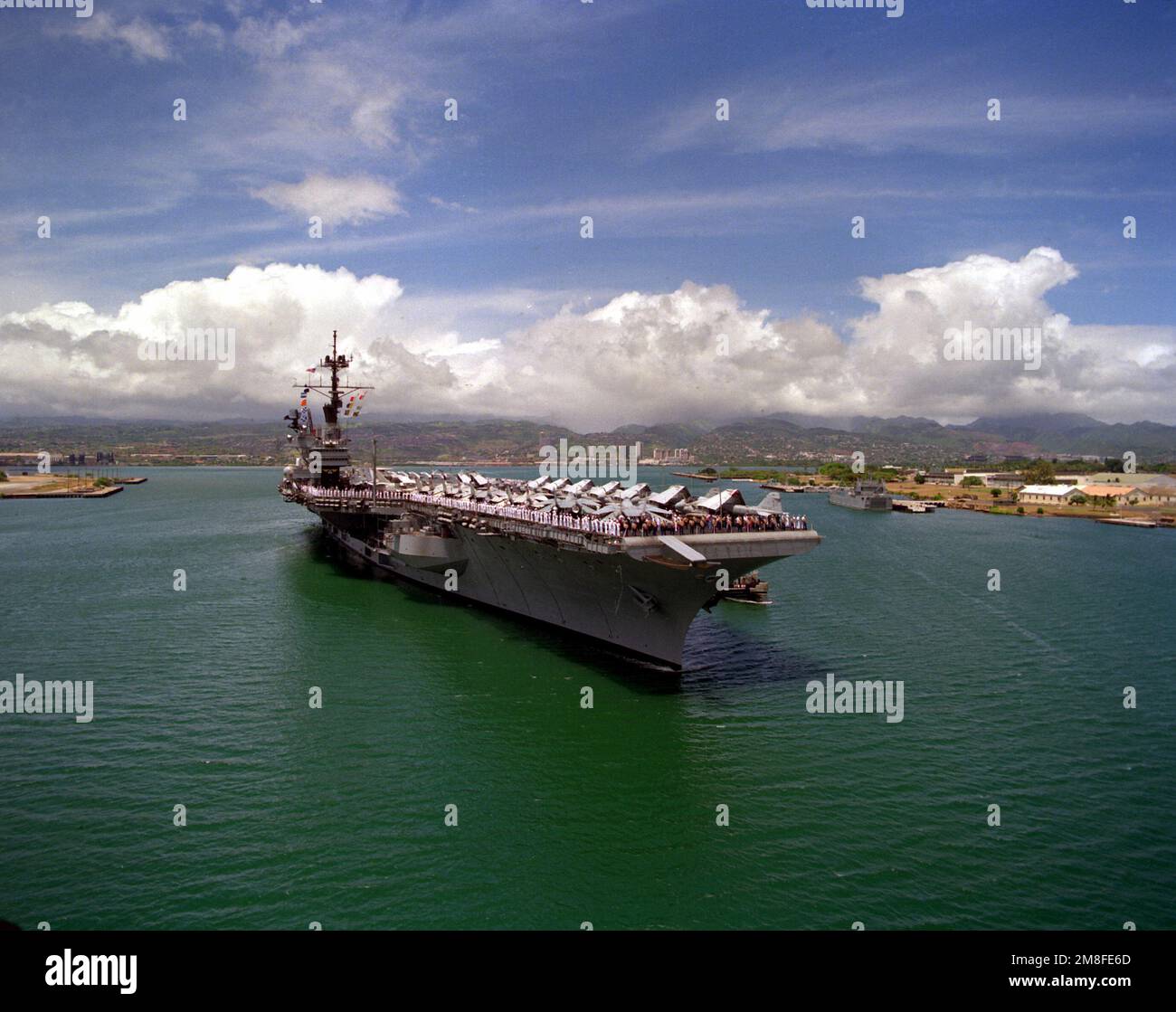 Sailors man the rails aboard the aircraft carrier USS RANGER (CV-61) as ...