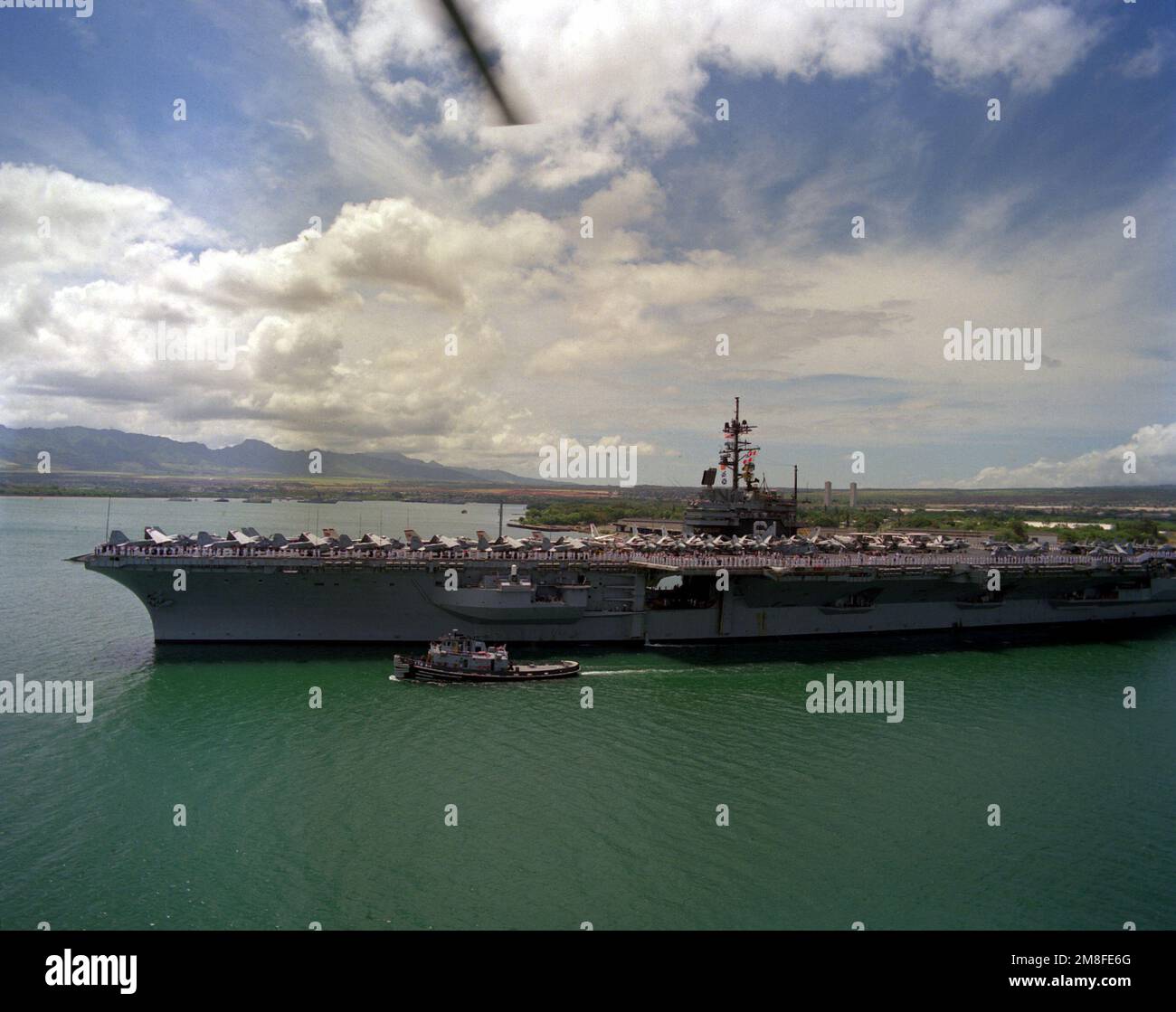 Sailors man the rails aboard the aircraft carrier USS RANGER (CV-61) as ...