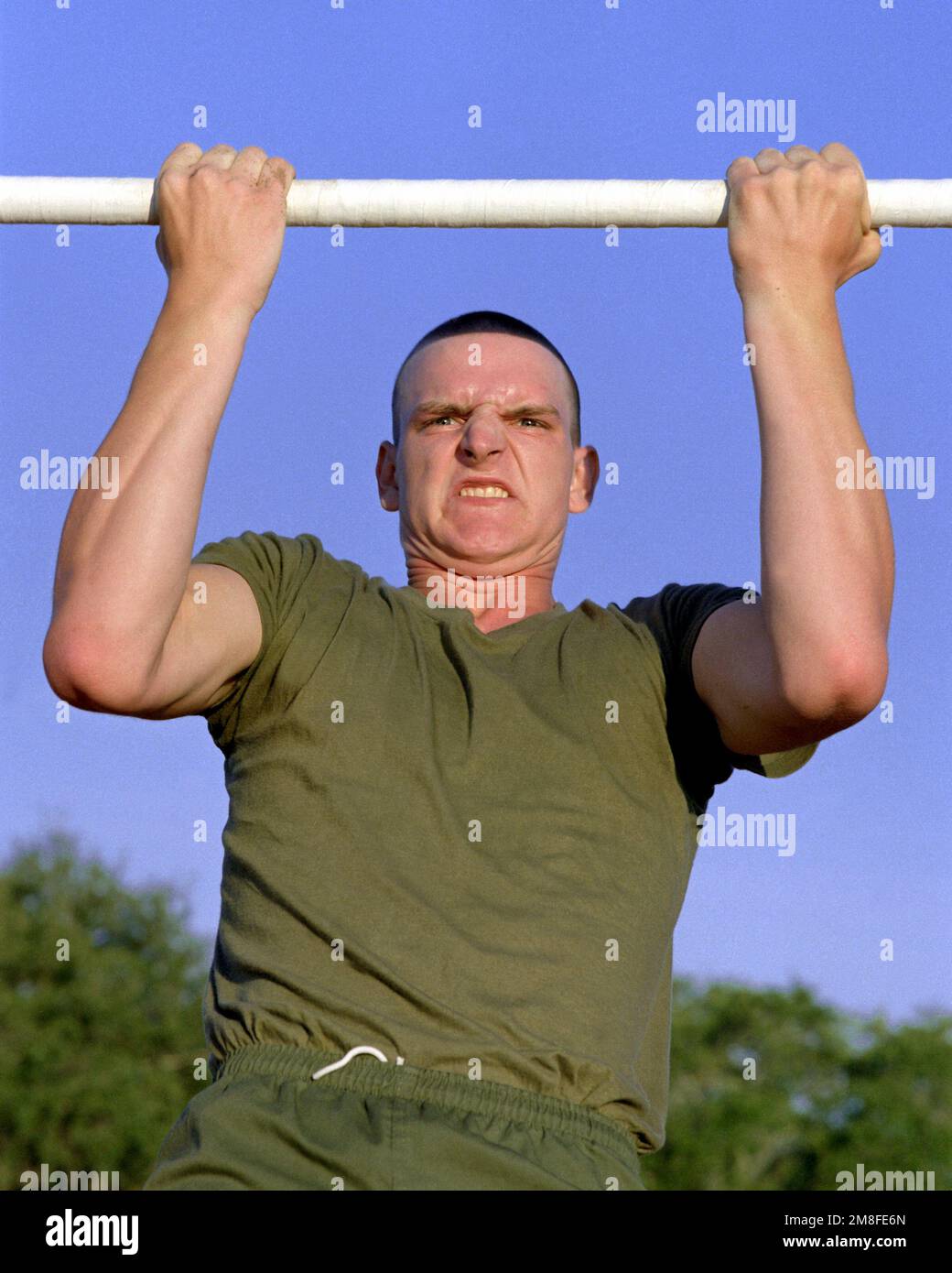 A 1ST Battalion recruit does pull-ups during a physical fitness test ...
