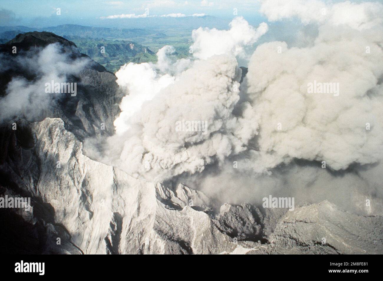 Clouds of ash pour from Mount Pinatubo as the volcano comes to life for ...