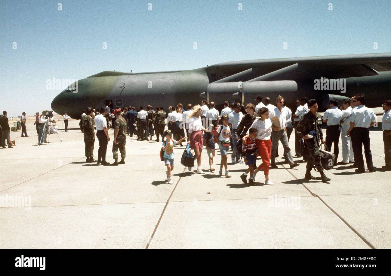 Military personnel prepare to board a C-141B Starlifter aircraft after ...