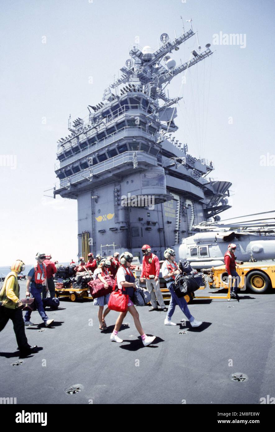 Families walk across the flight deck of the nuclear-powered aircraft ...