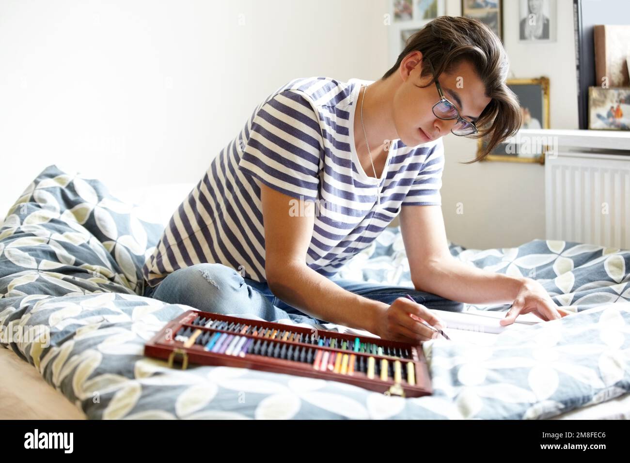 Expressing his creativity. Young artist working on something while at ...