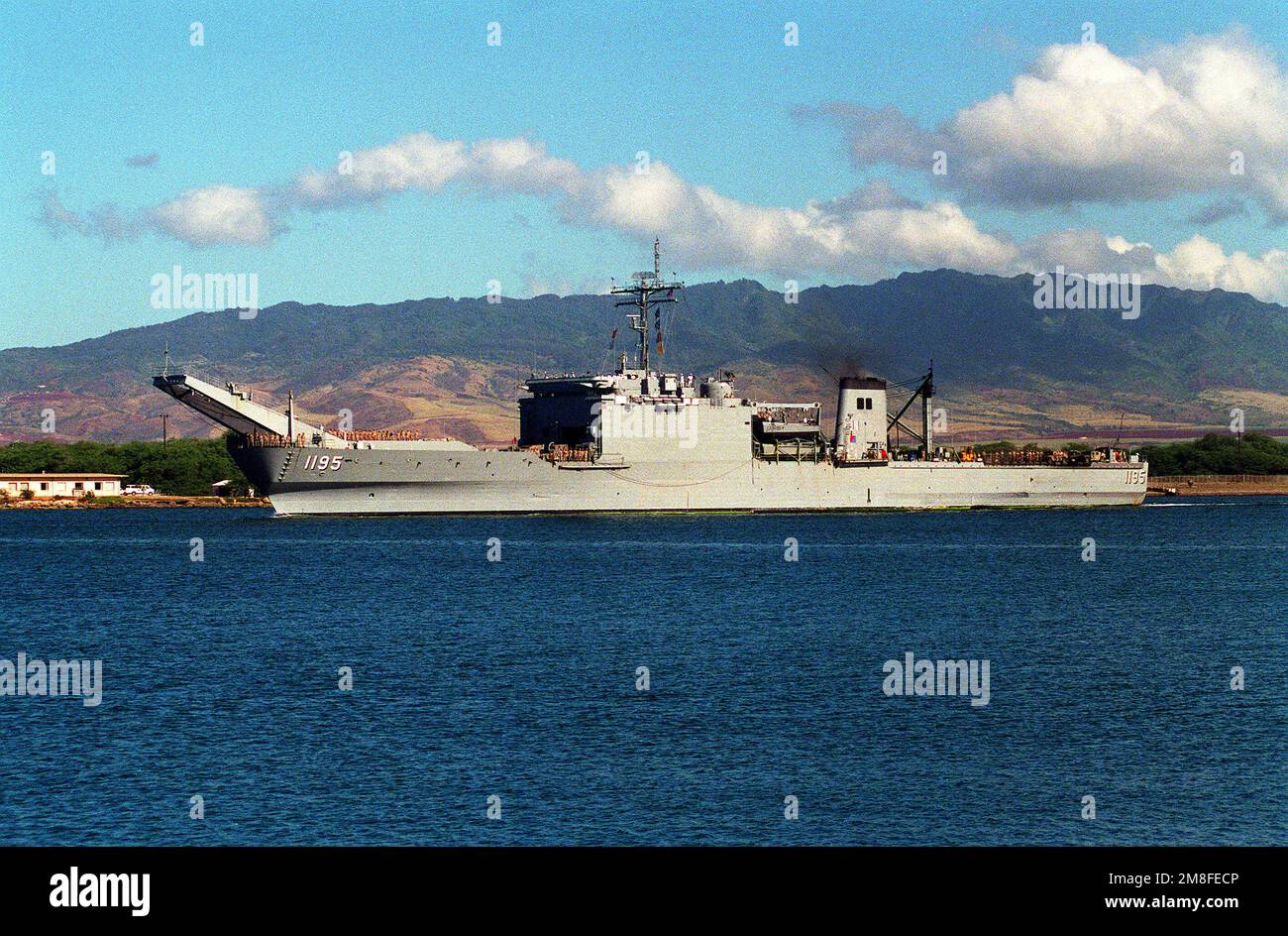 The tank landing ship USS BARBOUR COUNTY (LST-1195) departs from the ...