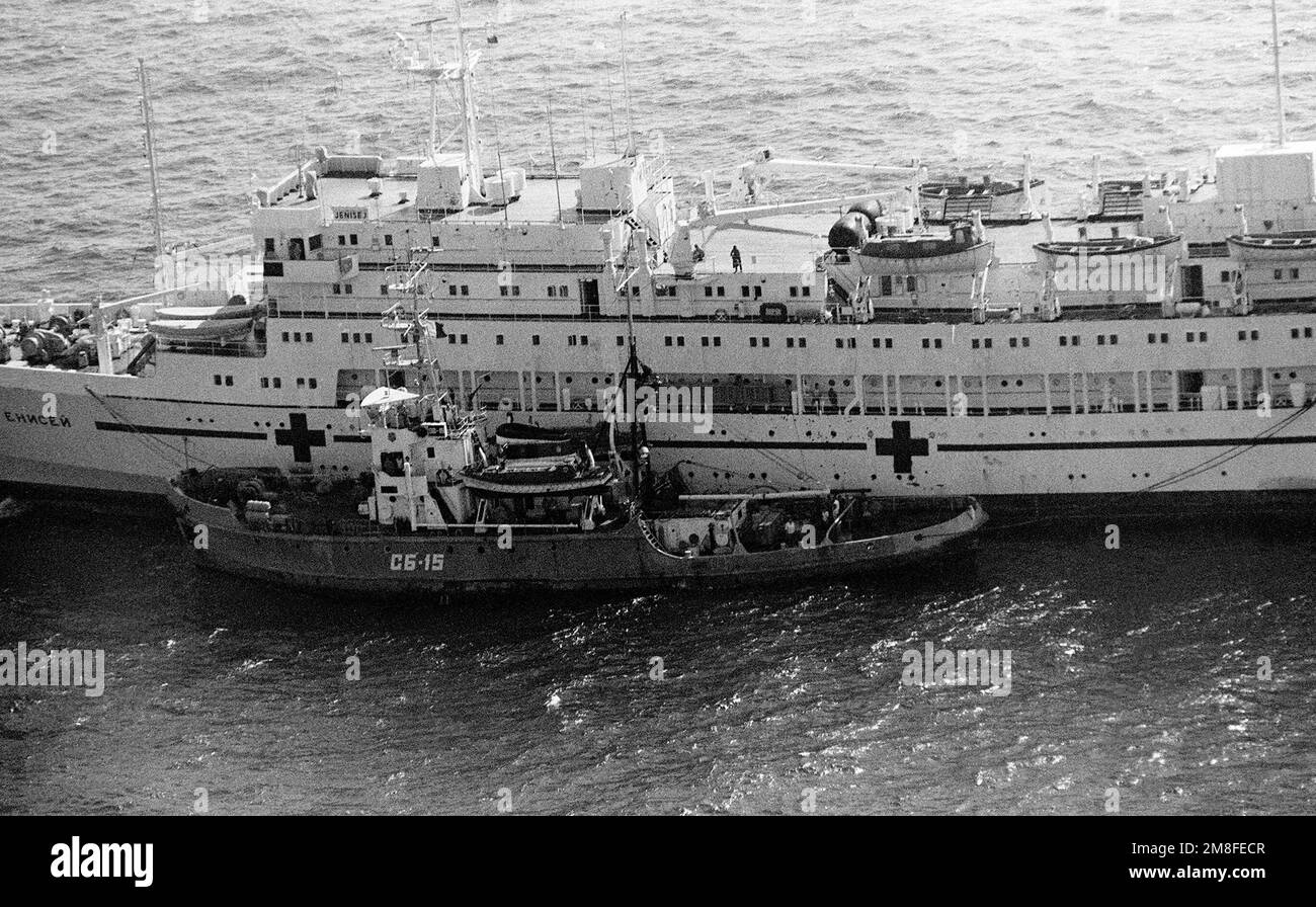 The Soviet Okhtensky class rescue tug SB-15 is moored to the Ob class ...
