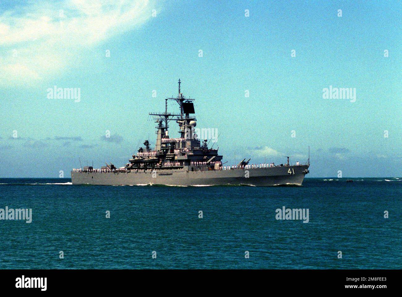 Crew members man the rails as the nuclear-powered guided missile ...
