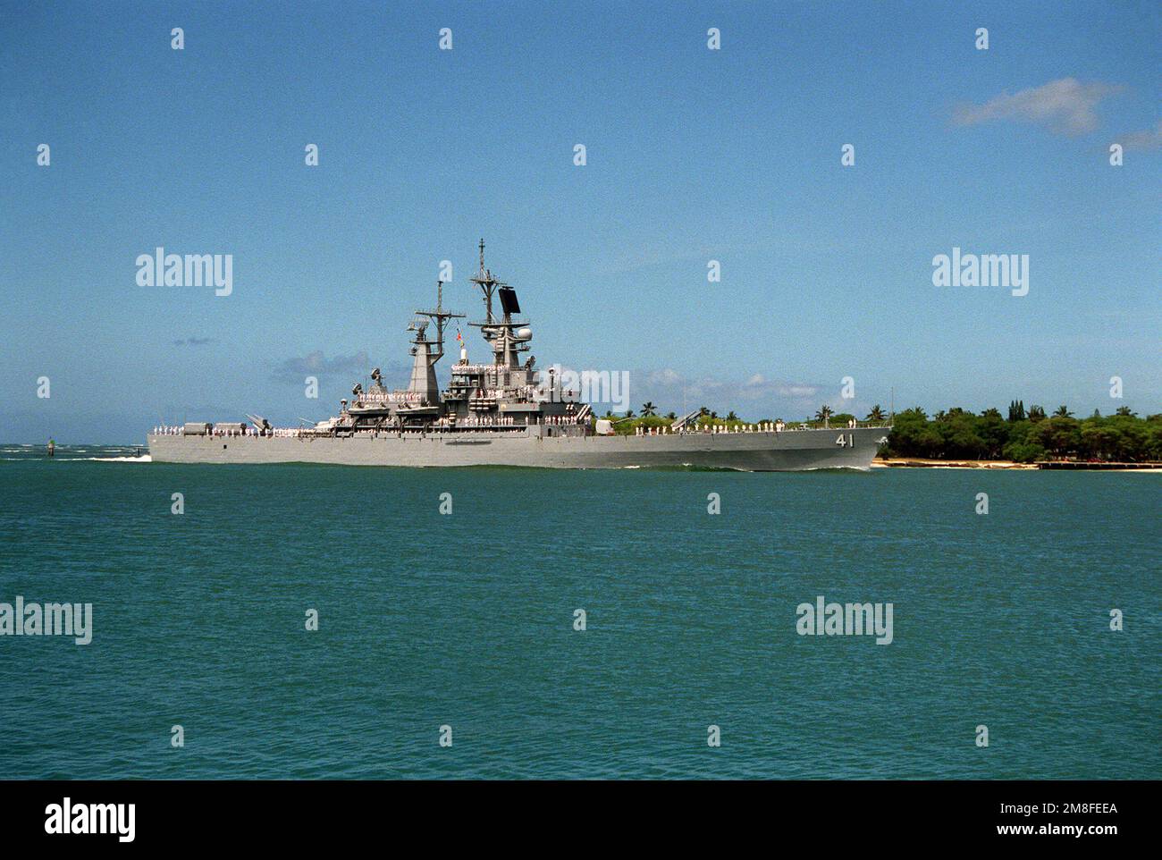 Crew members man the rails aboard the nuclear-powered guided missile ...