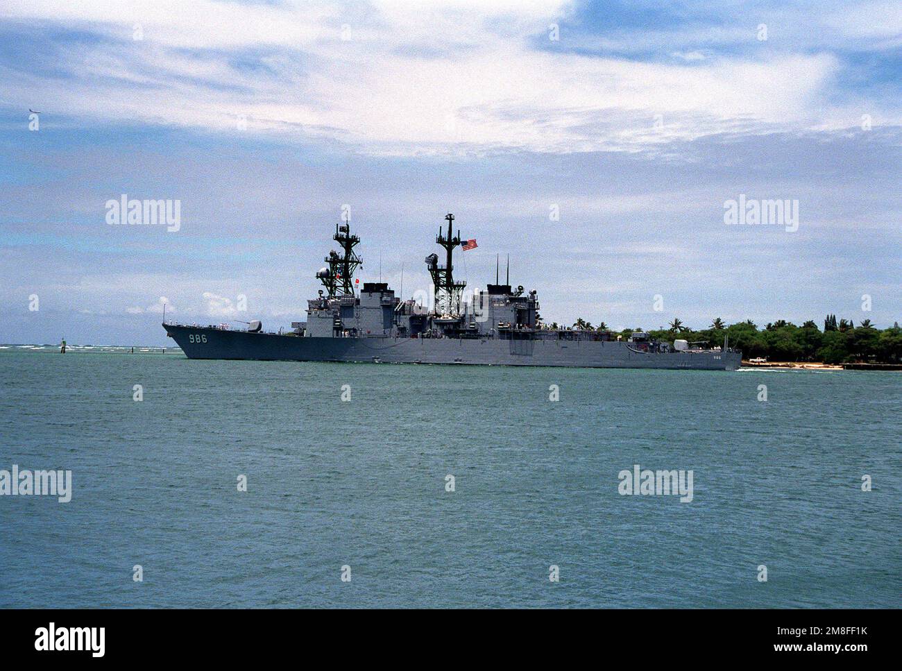 A port beam view of the destroyer USS HARRY W. HILL (DD-986) departing ...