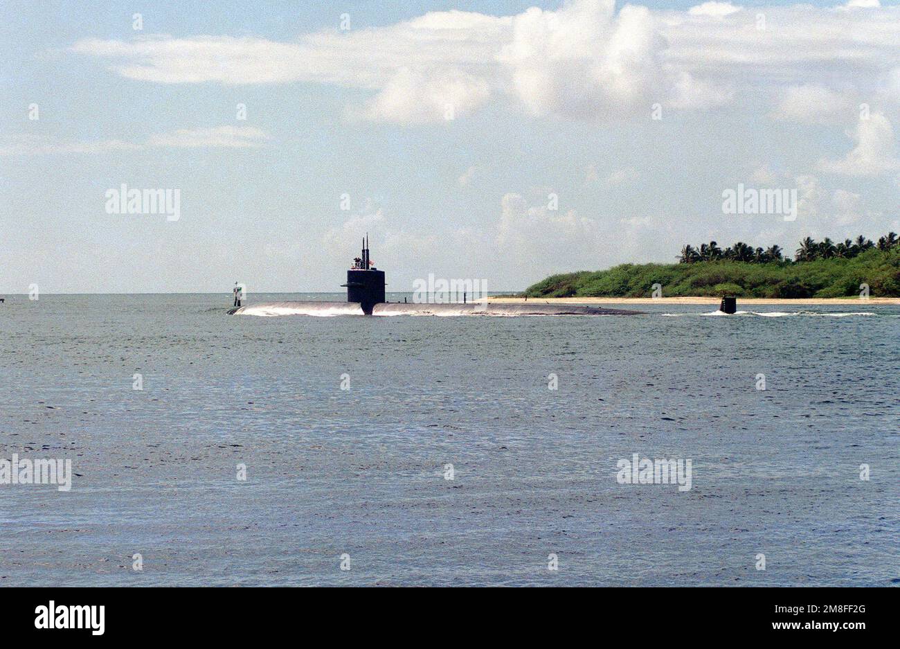 The nuclear-powered attack submarine USS BIRMINGHAM (SSN-695) heads for ...