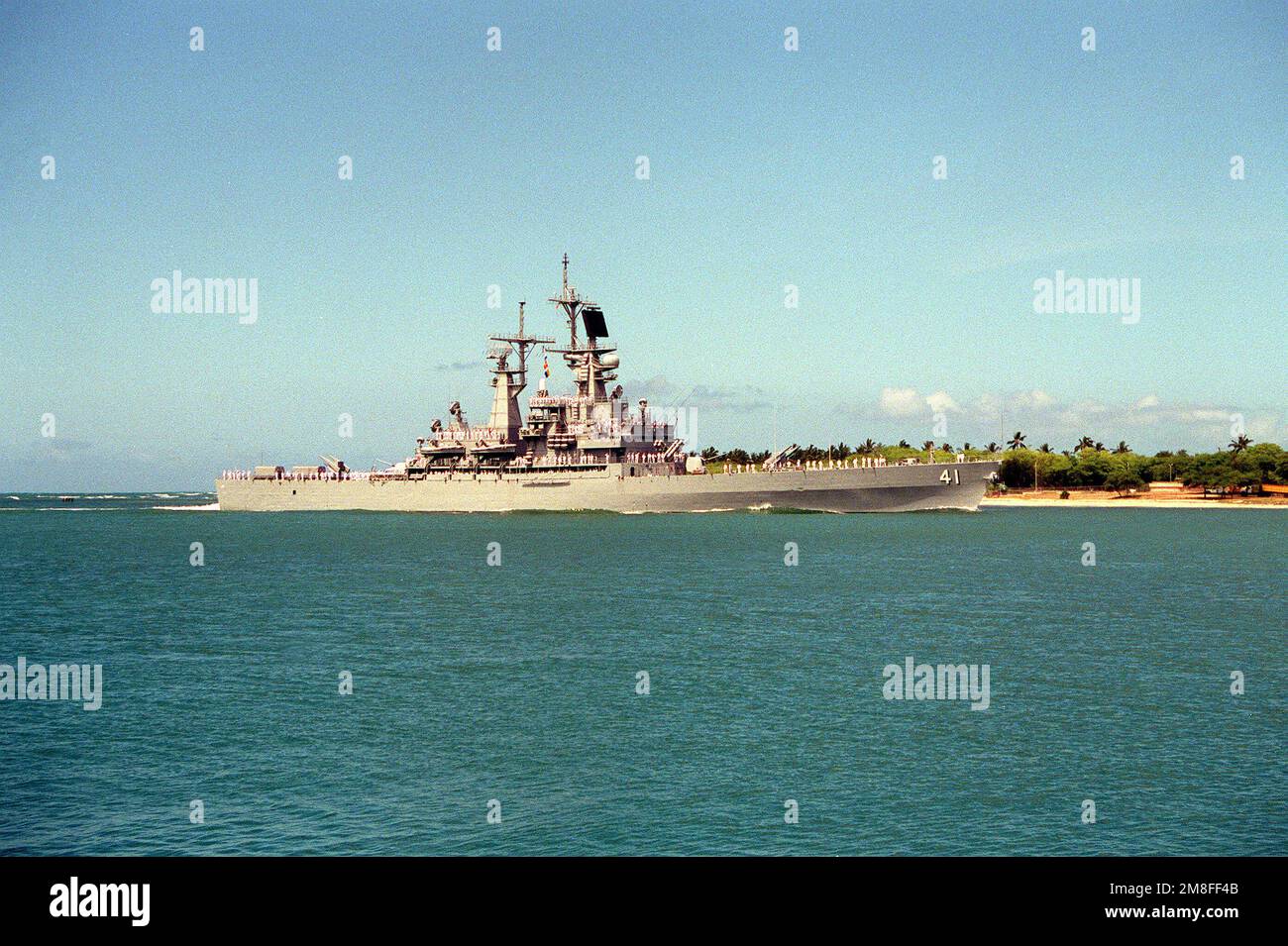 Crew members man the rails aboard the nuclear-powered guided missile ...